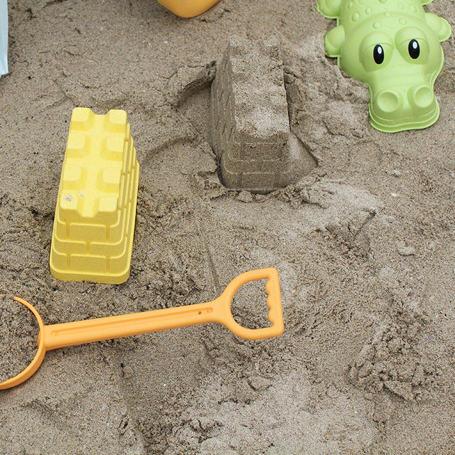 Children's beach toys for babies playing at the beach, digging sand and ...