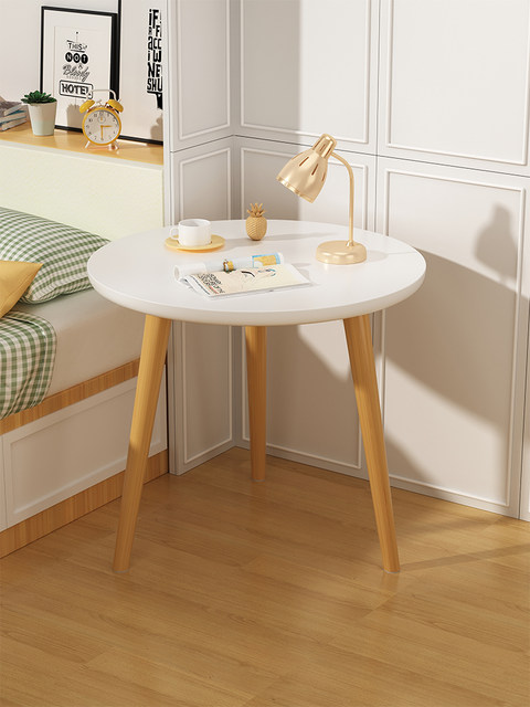 A few corners of the bedside table at the small round table, a few ...