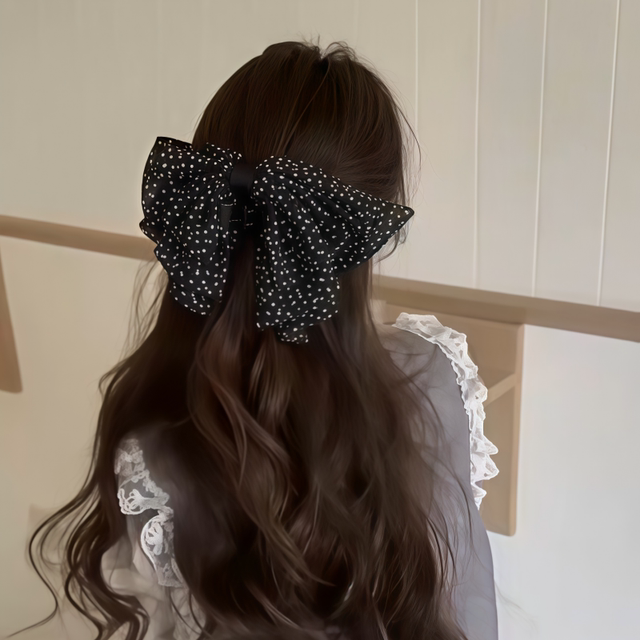 French black polka dot bow scratching small half-tied hair ponytail ...