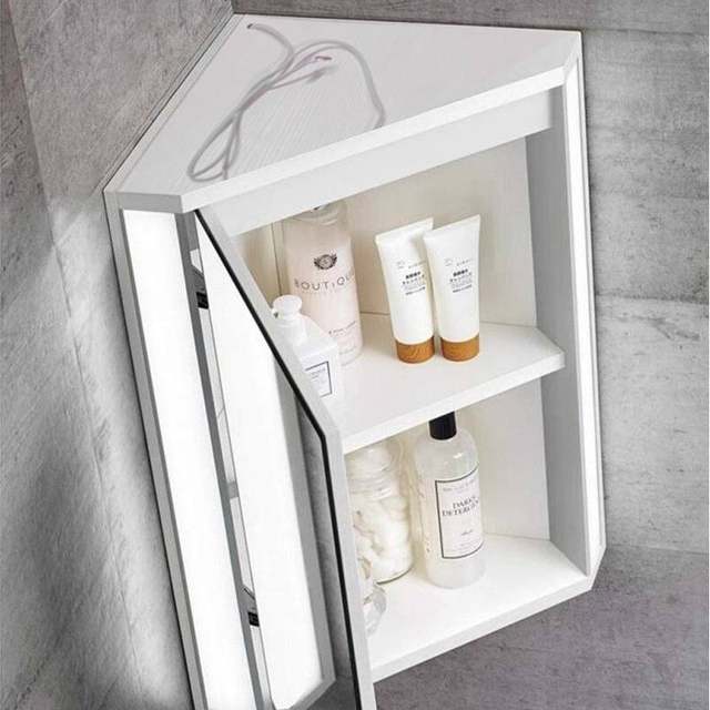 Triangular mirror cabinet with a lamp washed the wall corner of the ...